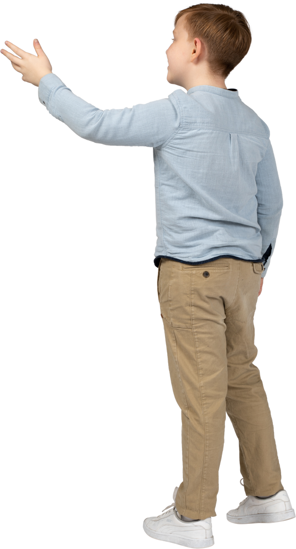 Back view of a boy waving Photo