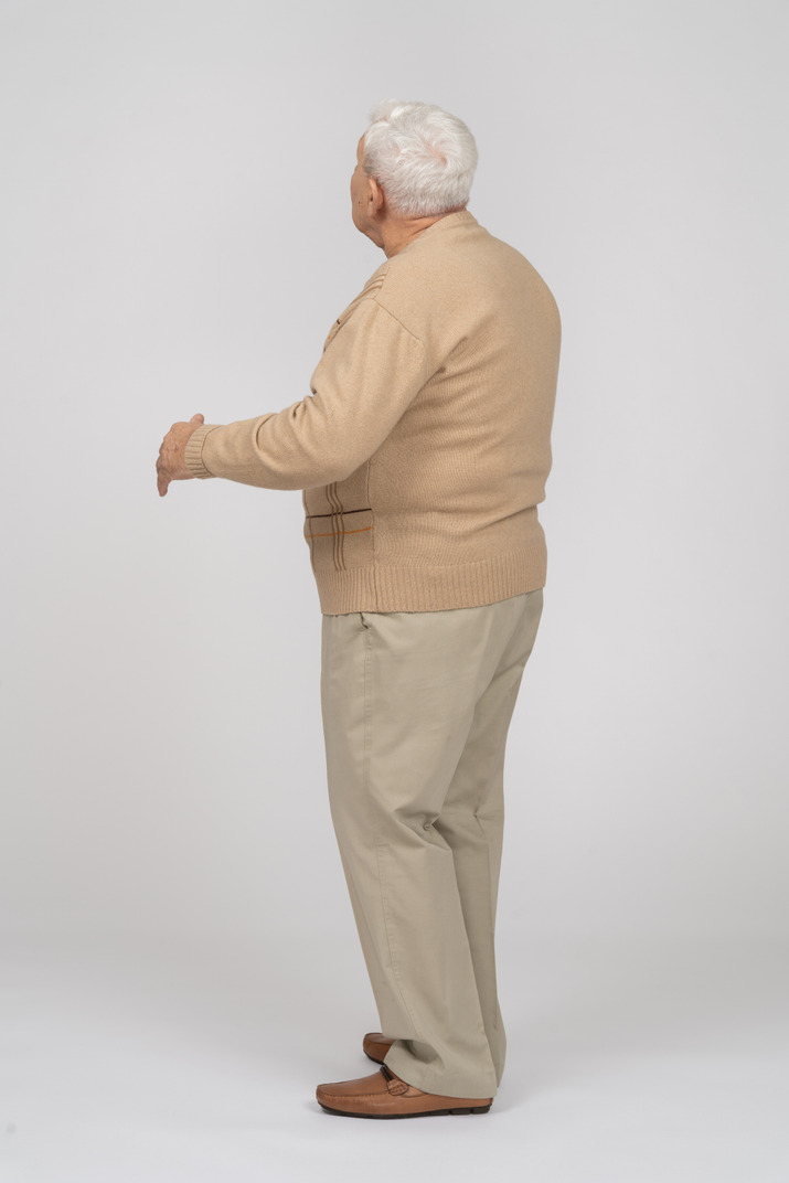 Side view of an impressed old man in casual clothes looking up Photo
