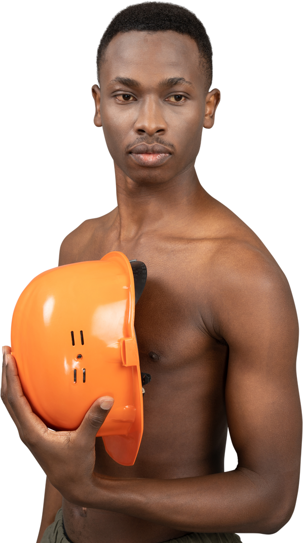 A shirtless young man holding a safety helmet Photo