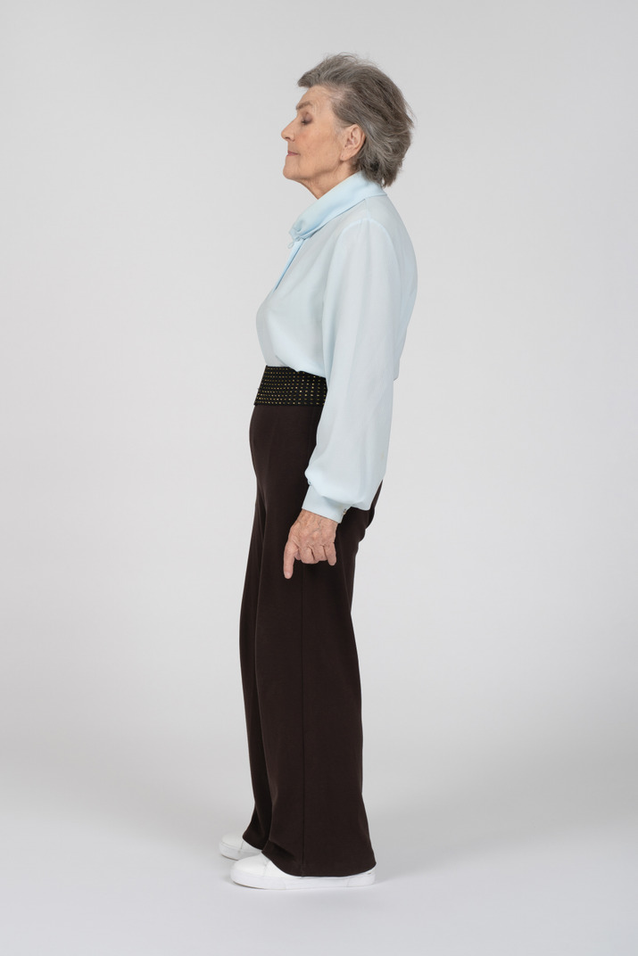 Side view of old lady standing still Photo