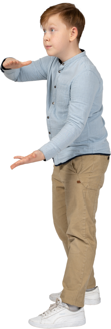 Side view of a boy showing size of something Photo