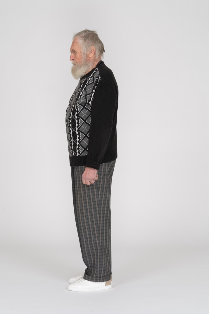 Side view of an old man standing Photo