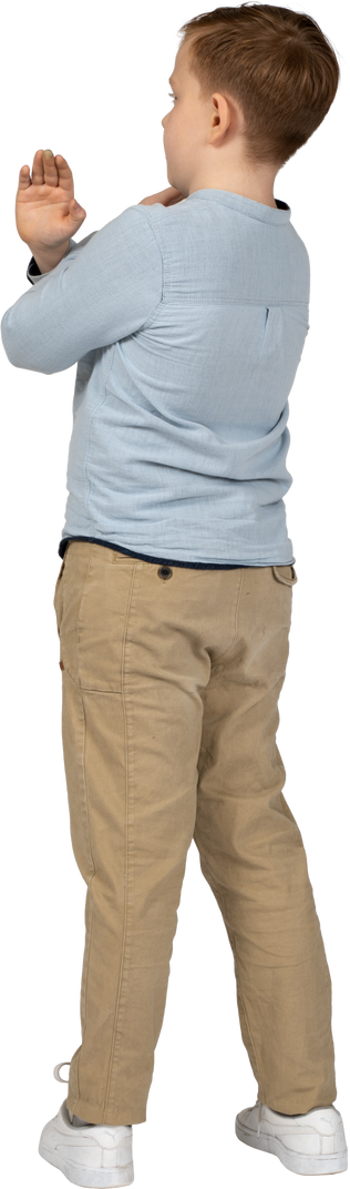 Back view of a boy making stop gesture Photo