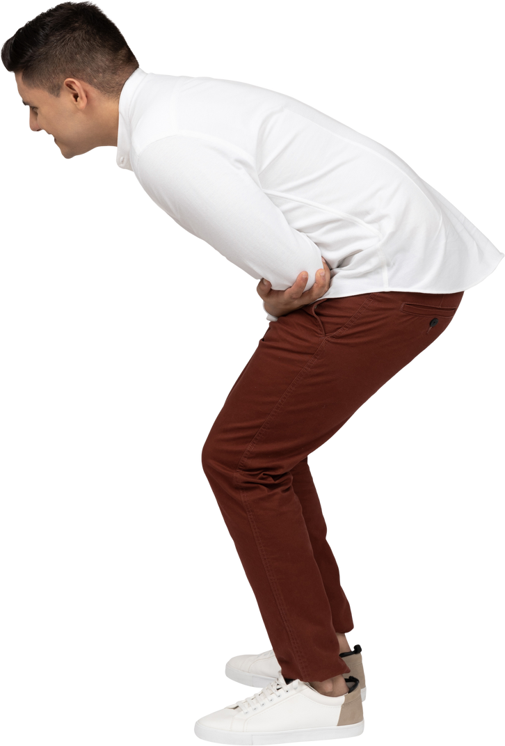 Side view of a young latino man crouching and laughing hard Photo