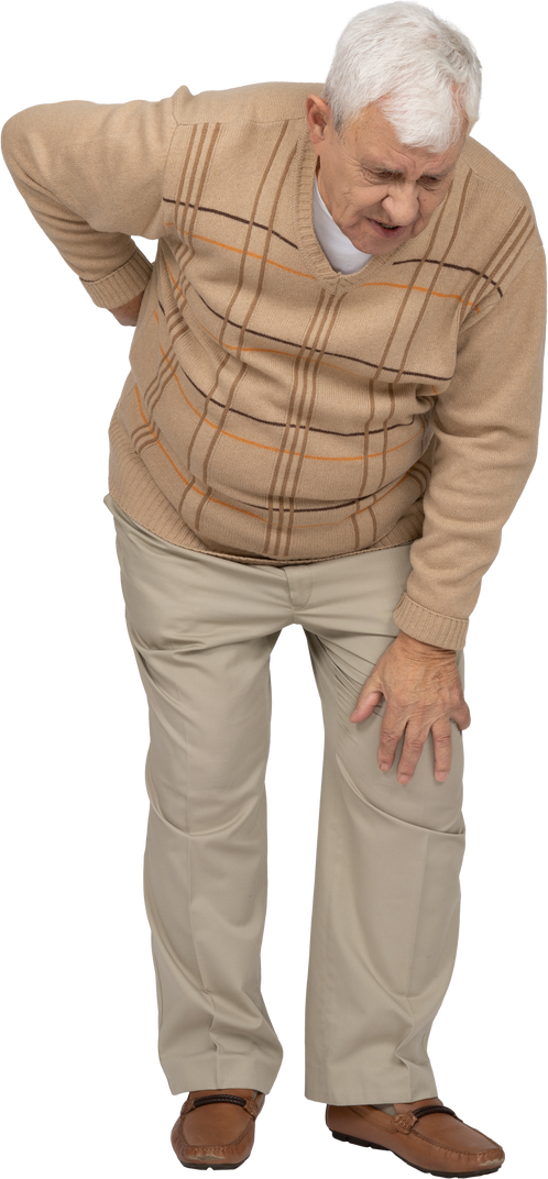 Front view of an old man bending down and touching knee Photo