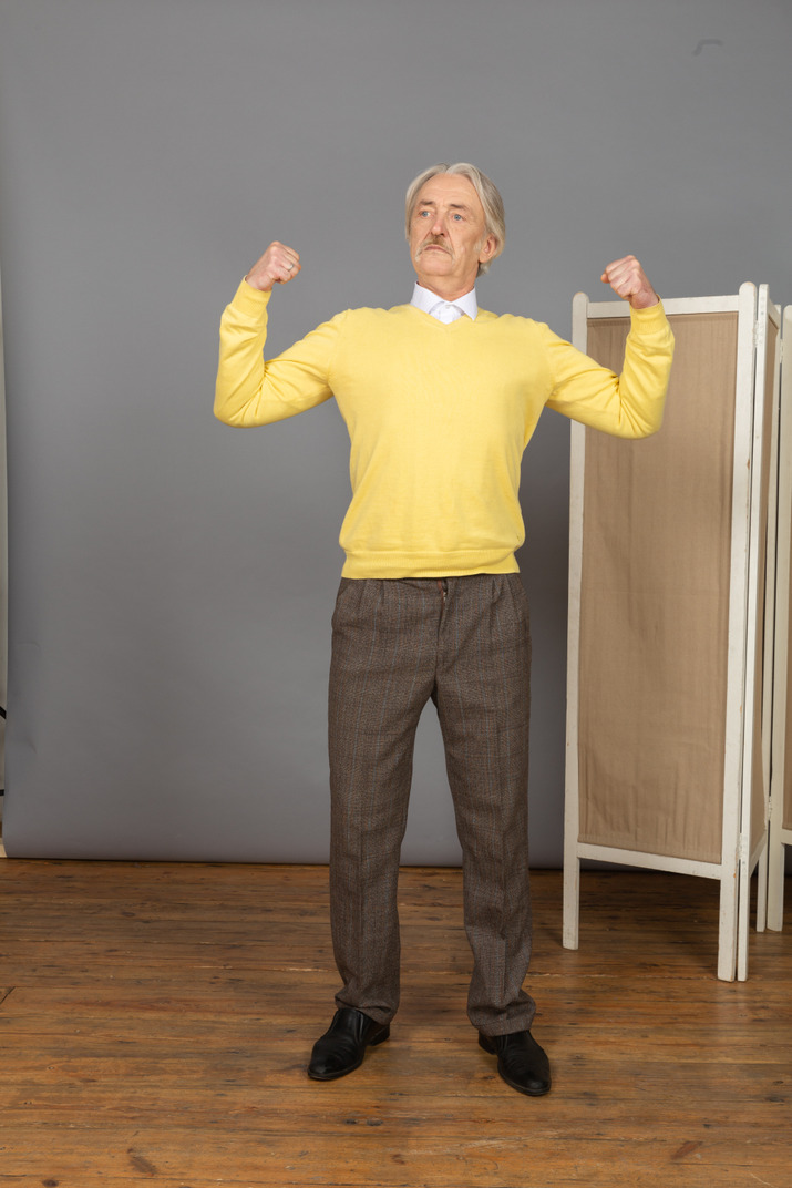 Front view of a strong old man demonstrating his strength Photo