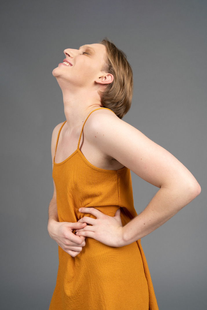 Side view of a transgender person smiling and tilting their head back Photo