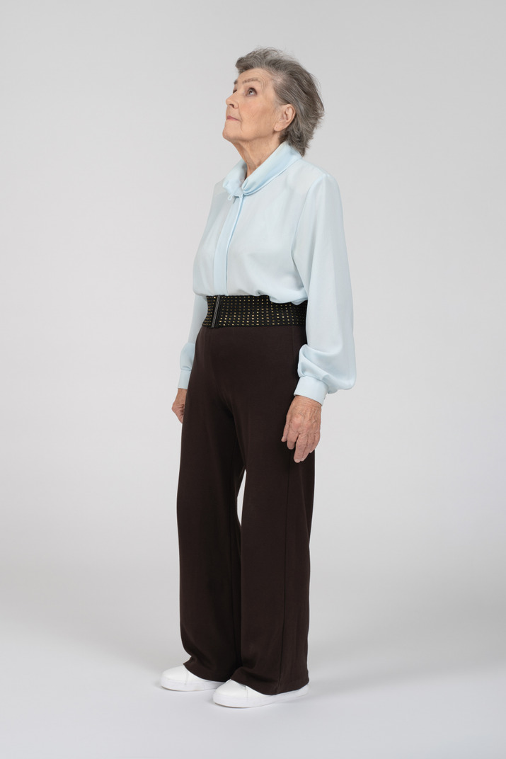 Three-quarter view of an old woman looking up Photo