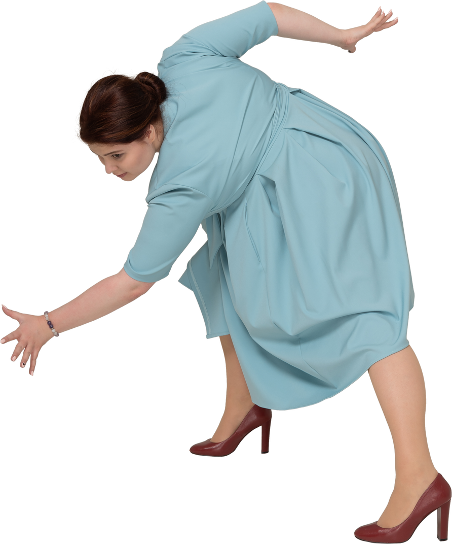 Side view of a woman in blue dress bending down Photo