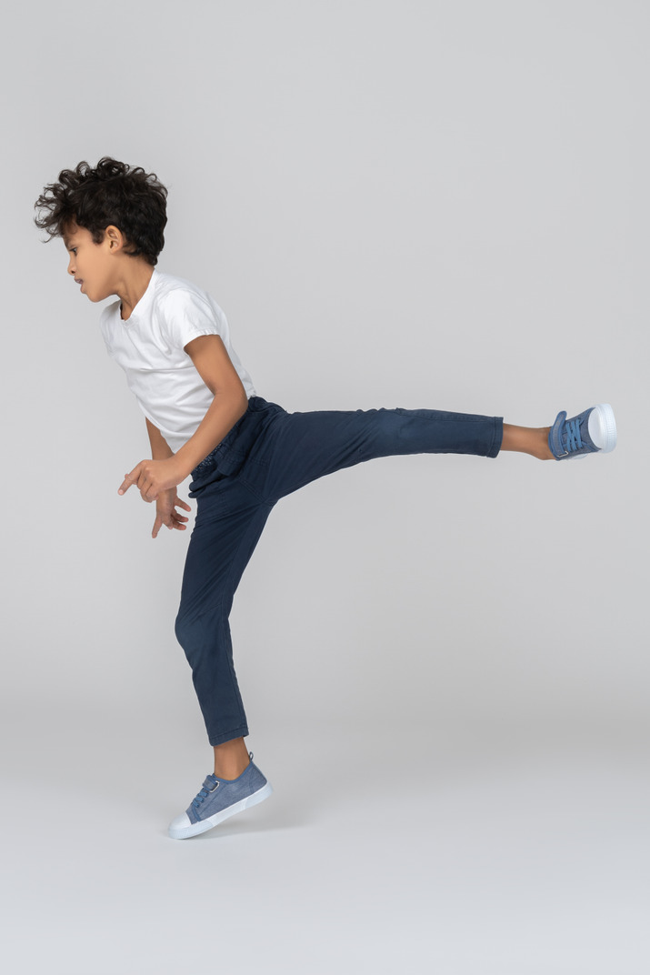A boy standing on one leg Photo