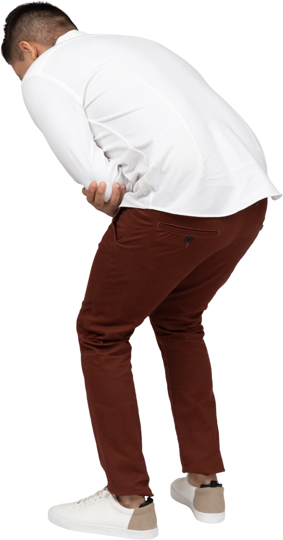 Three-quarter back view of a young latino man crouching and laughing ...