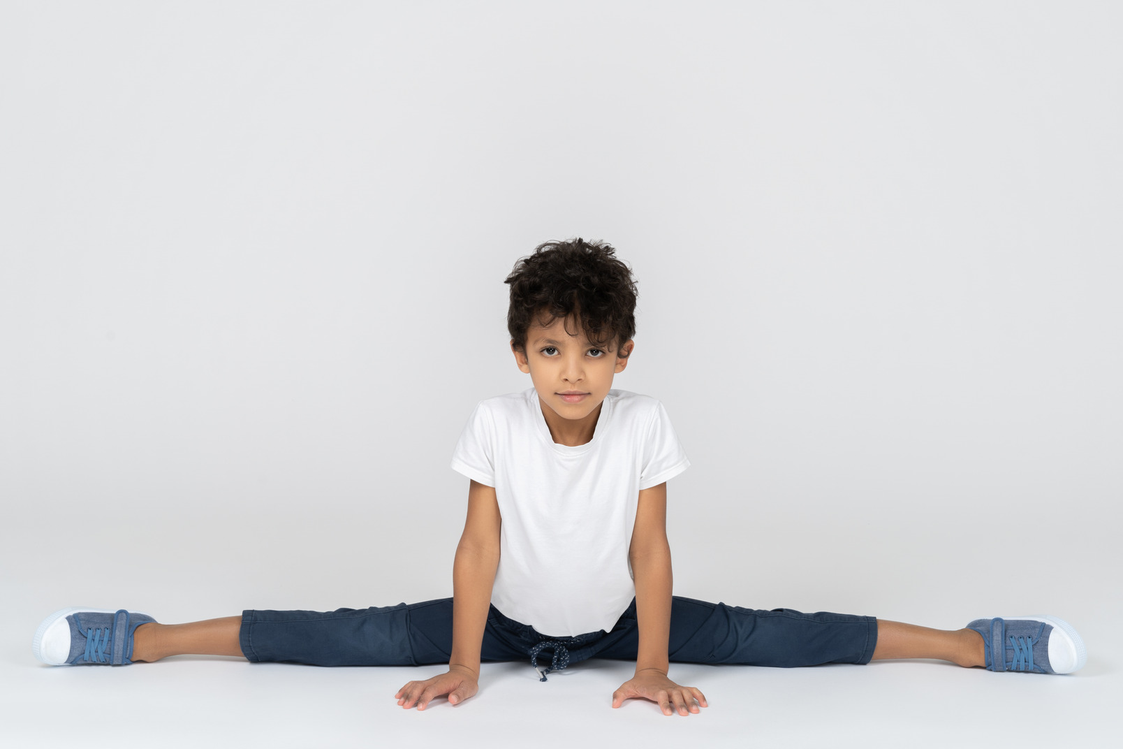 A boy doing split exercise Photo